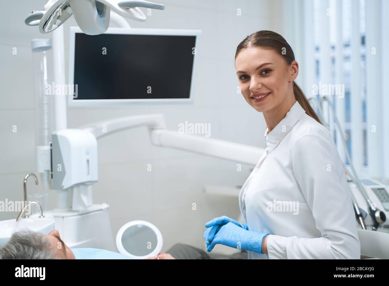 Happy female dentist during appointment stock photo Stock Photo - Alamy
