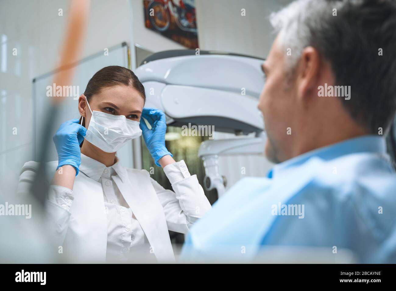 Cheerful dentist seeing patient in office stock photo Stock Photo - Alamy