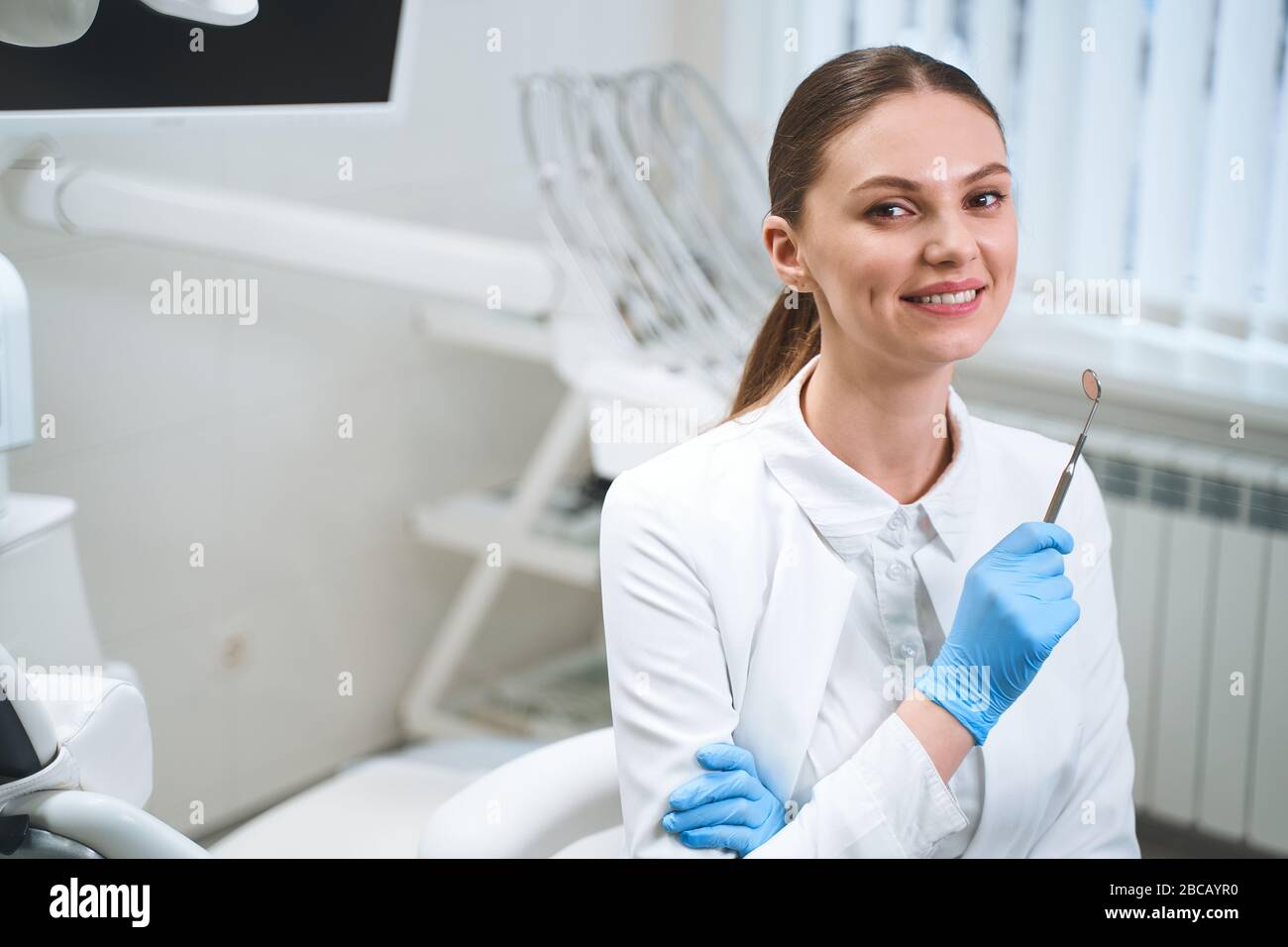 Happy pretty dentist at workplace stock photo Stock Photo - Alamy