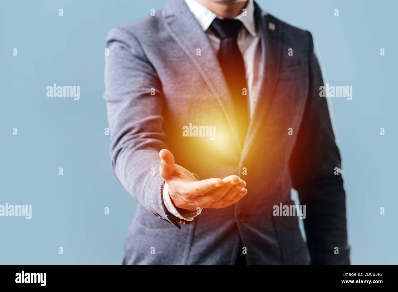 Man holds his hand in front of him showing off an object in the palm of ...