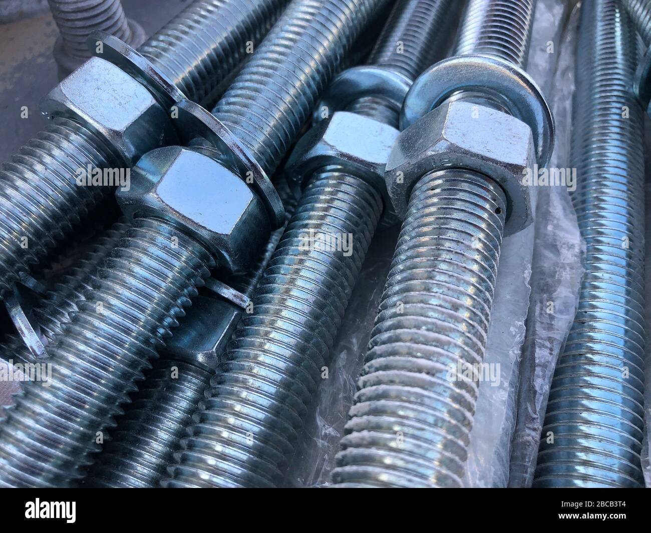 threaded fastening metal studs with nuts and washers Stock Photo - Alamy