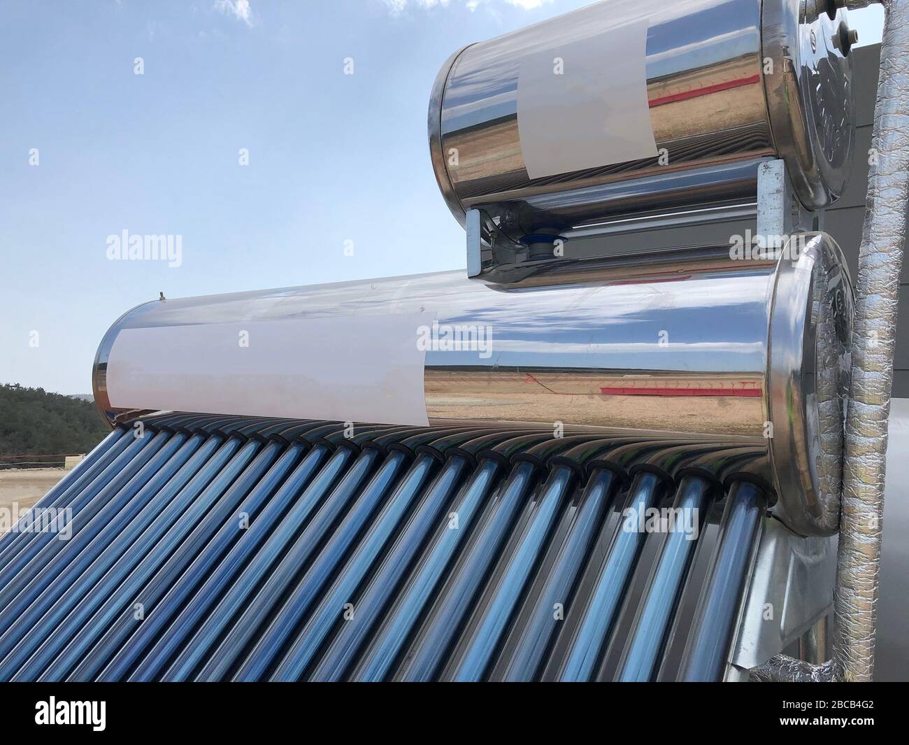 brand new water tank with solar heating elements Stock Photo - Alamy