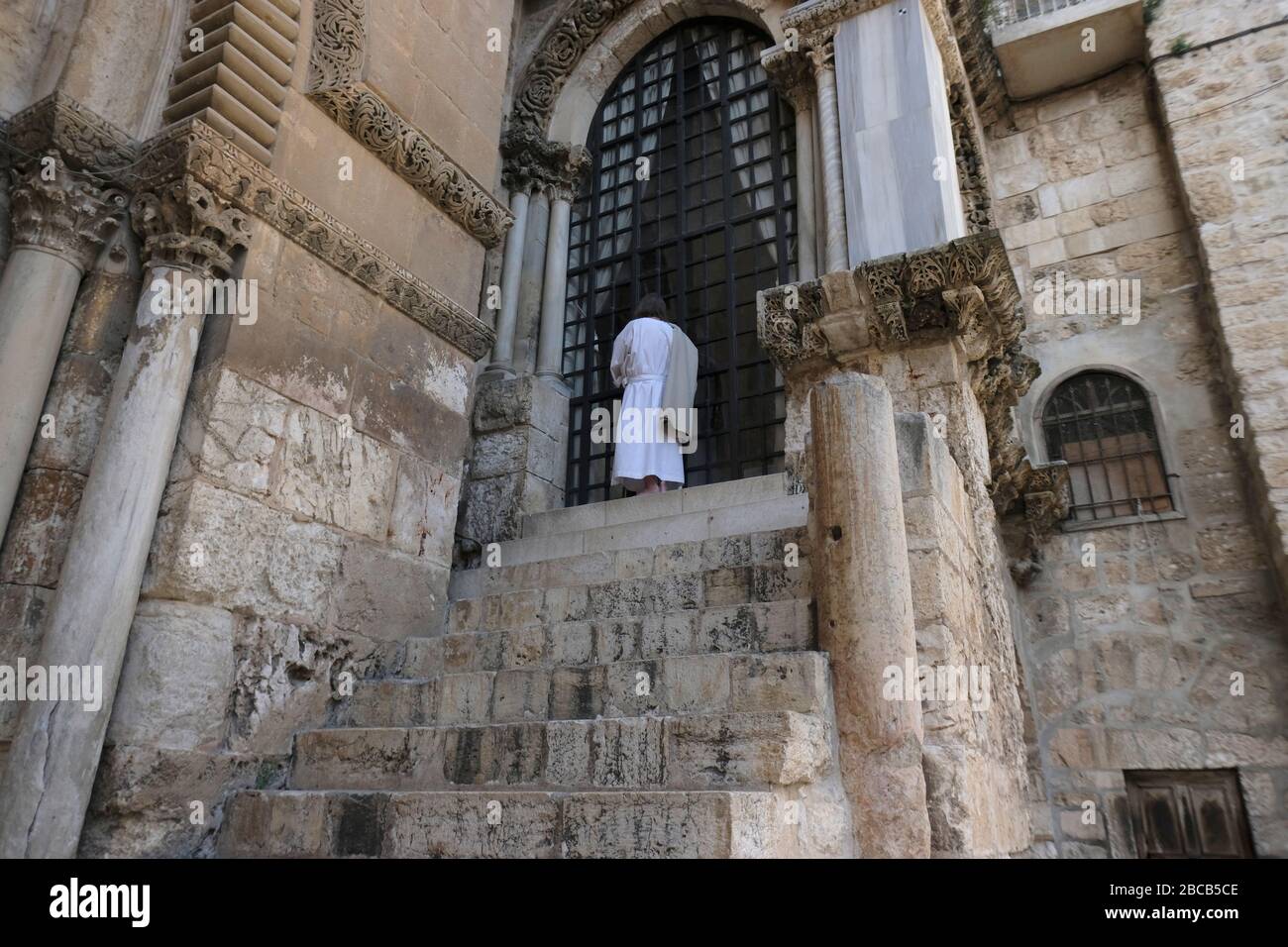 A Christian worshiper stands at the entrance to the small chapel ...