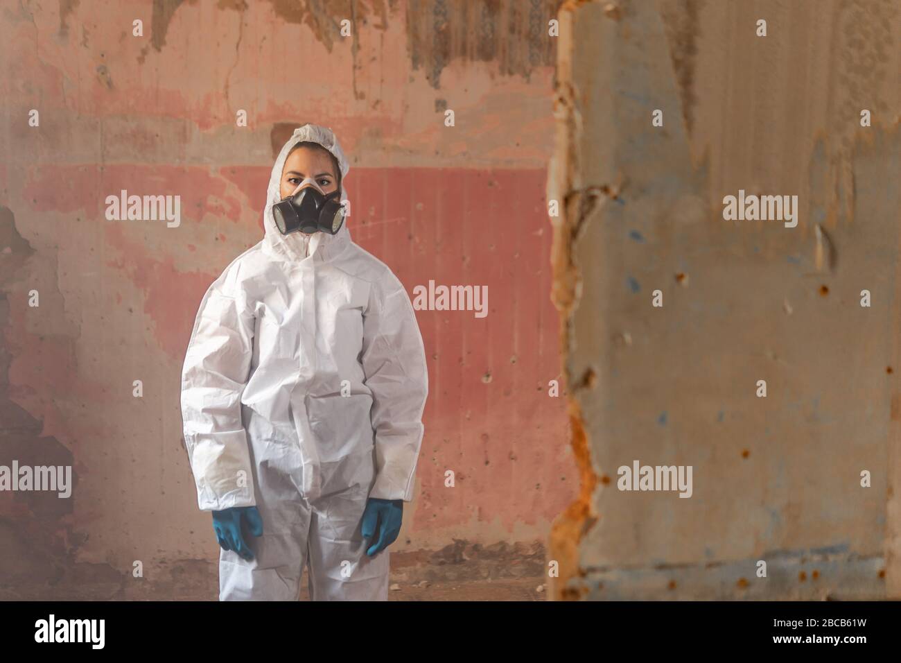 Young virologist doctor woman wearing a white biohazard protective suit ...
