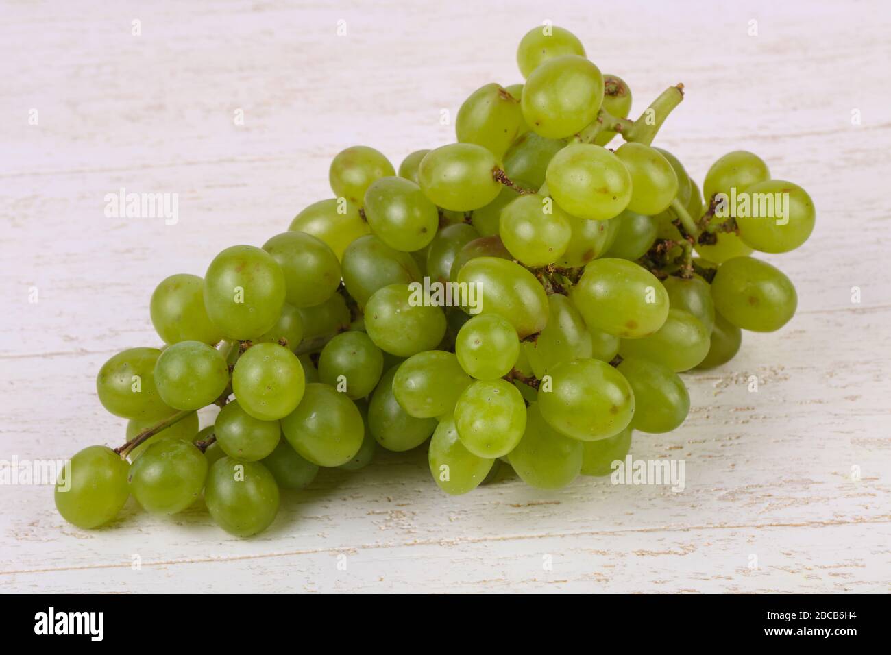 Sweet green grape branch over background Stock Photo - Alamy