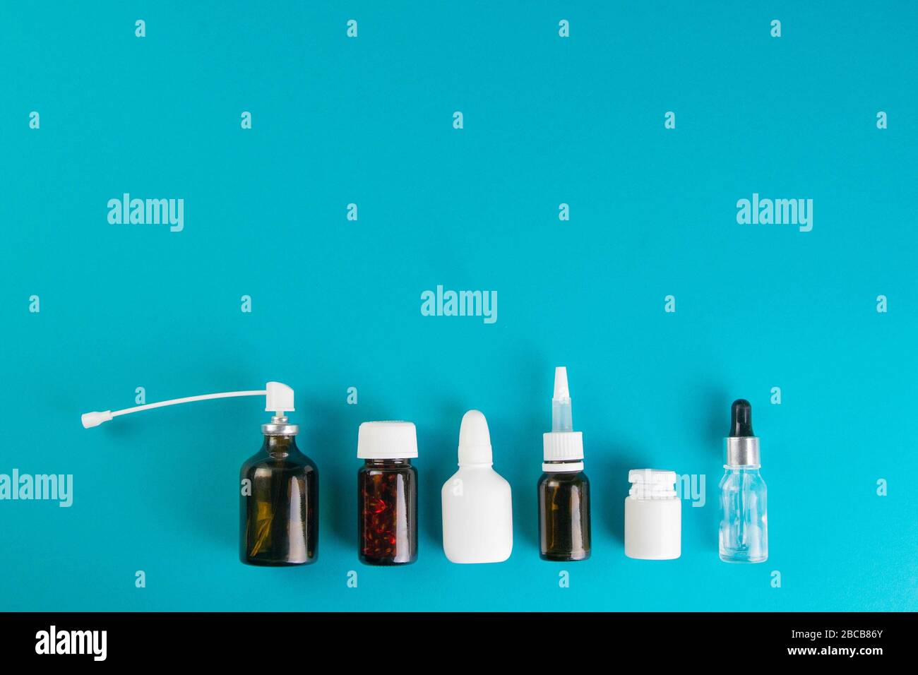 Different vials with and sprays with medicines are lined in a straight ...