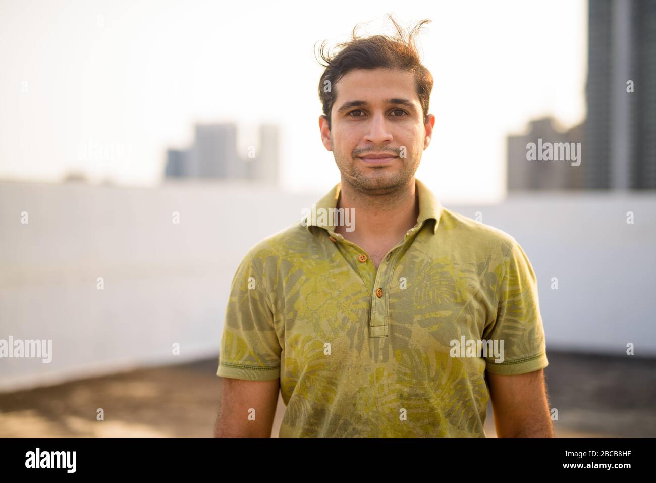 Young handsome Persian man against view of the city Stock Photo - Alamy
