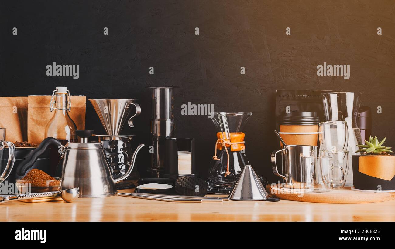 Accessories and utensils for making coffee drinks on a wooden table ...