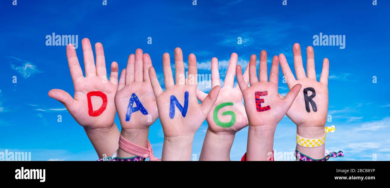 Children Hands Building Word Danger, Blue Sky Stock Photo - Alamy