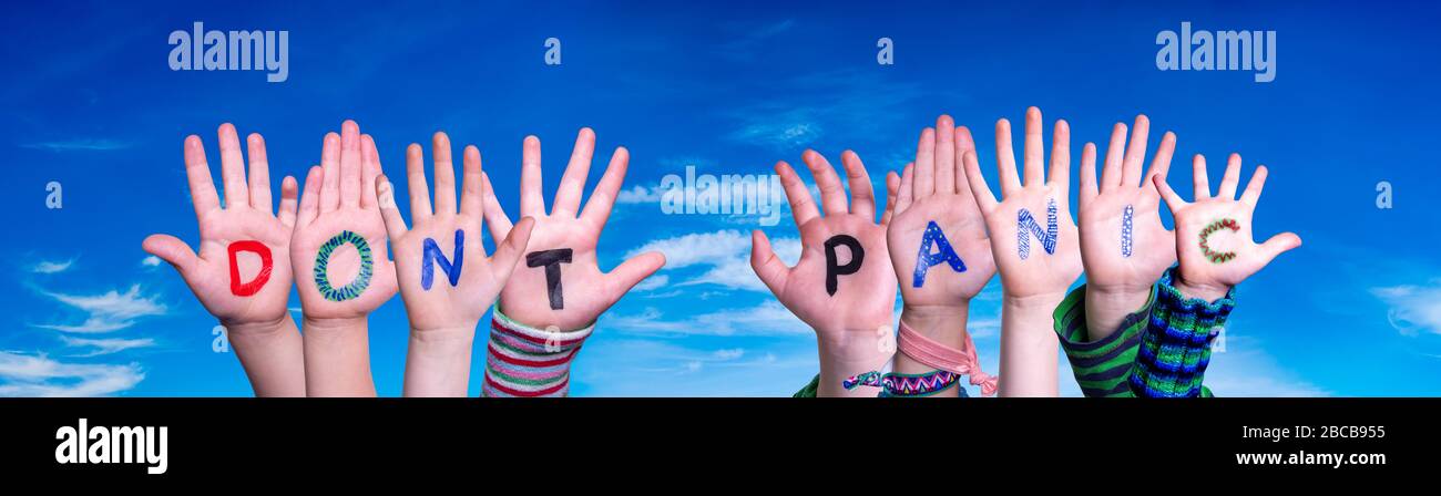 Kids Hands Holding Word Do Not Panic, Blue Sky Stock Photo - Alamy