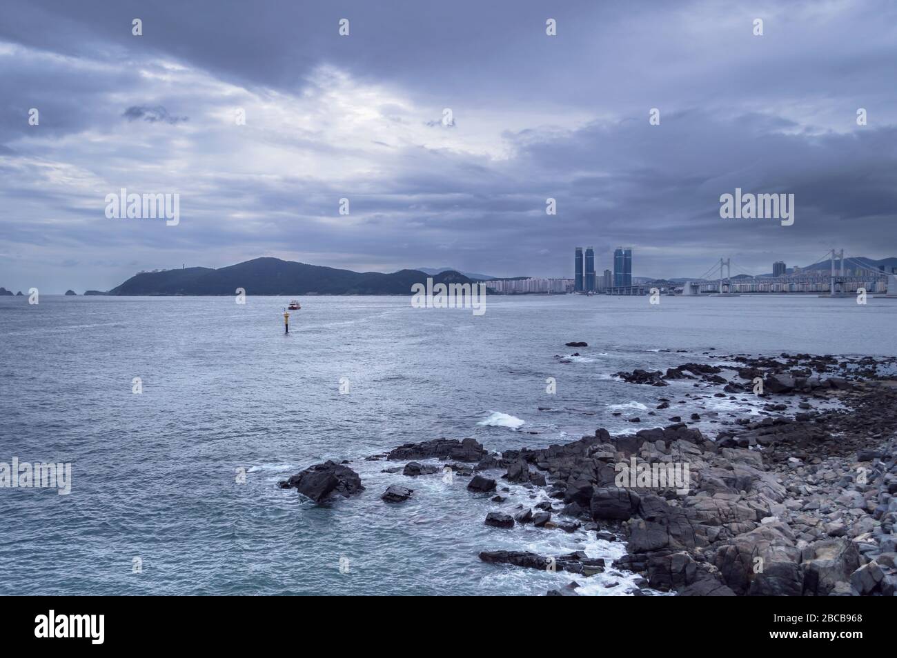 view form Dongbaekseom island on cityscape of Busan with overcast skies ...