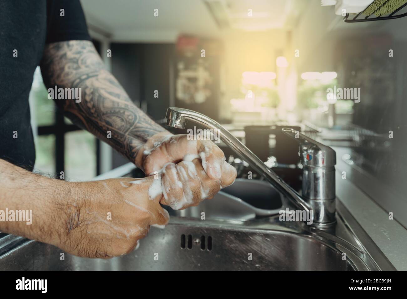A man washing his hands with foam hand wahs for corona virus prevention ...