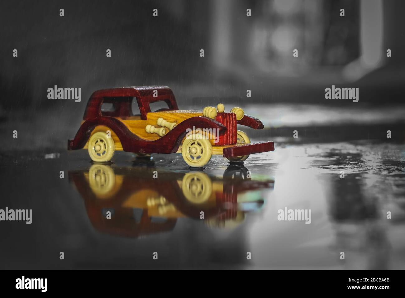 Reflection Vintage toy car under the rain on the road. Miniature Car ...