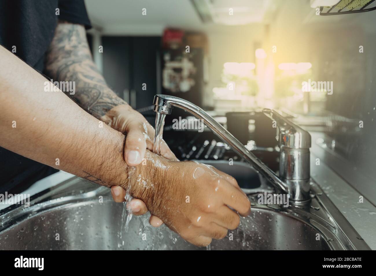 A man washing his hands with foam hand wahs for corona virus prevention ...