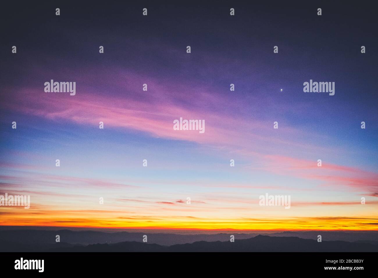 sky shading in the morning from orange to blue Stock Photo - Alamy