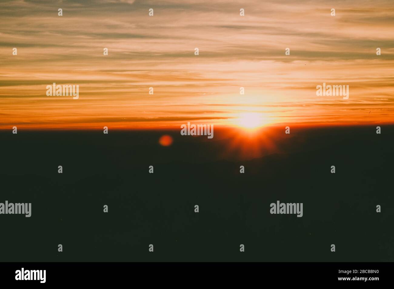 sunrise backlit sky with cloud on the top of mountain Stock Photo - Alamy