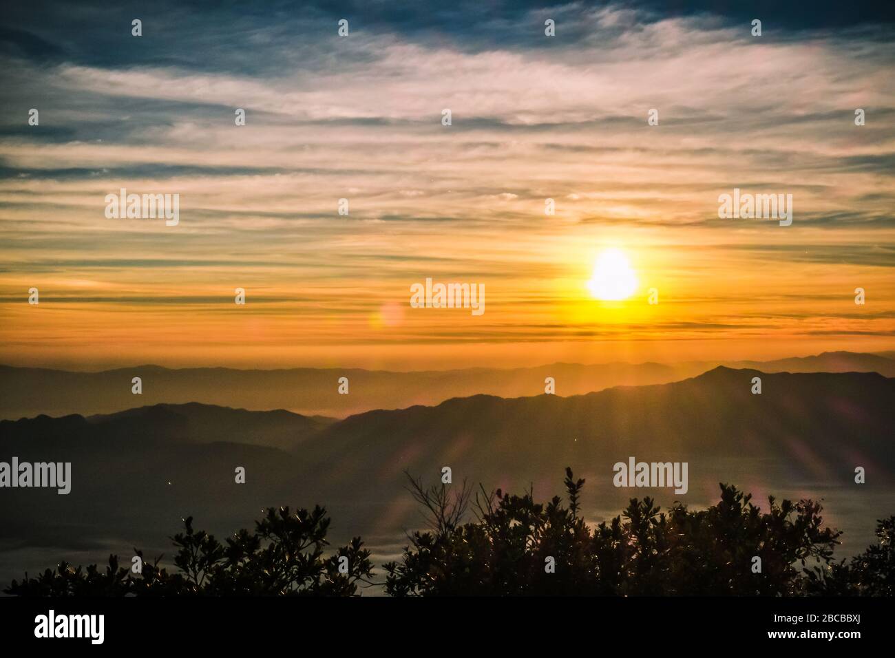 sunrise backlit sky with cloud on the top of mountain Stock Photo - Alamy