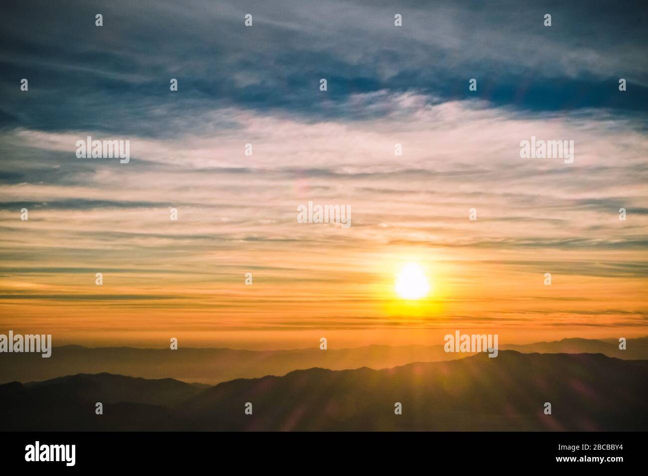 sunrise backlit sky with cloud on the top of mountain Stock Photo - Alamy