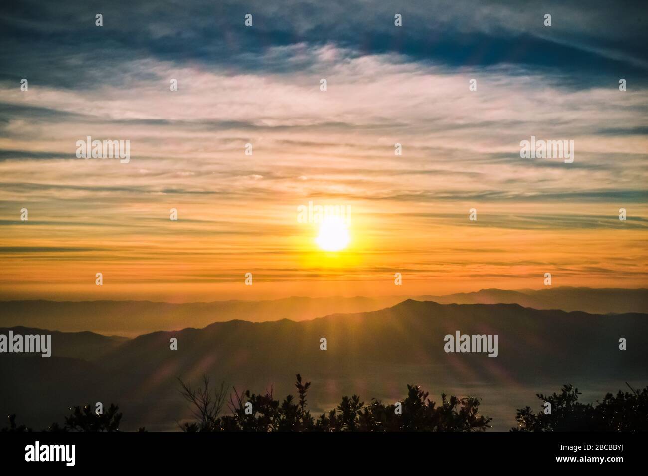 sunrise backlit sky with cloud on the top of mountain Stock Photo - Alamy