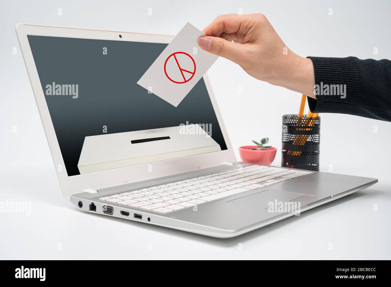 Online voting concept with a man with a ballot in hand putting a ballot ...