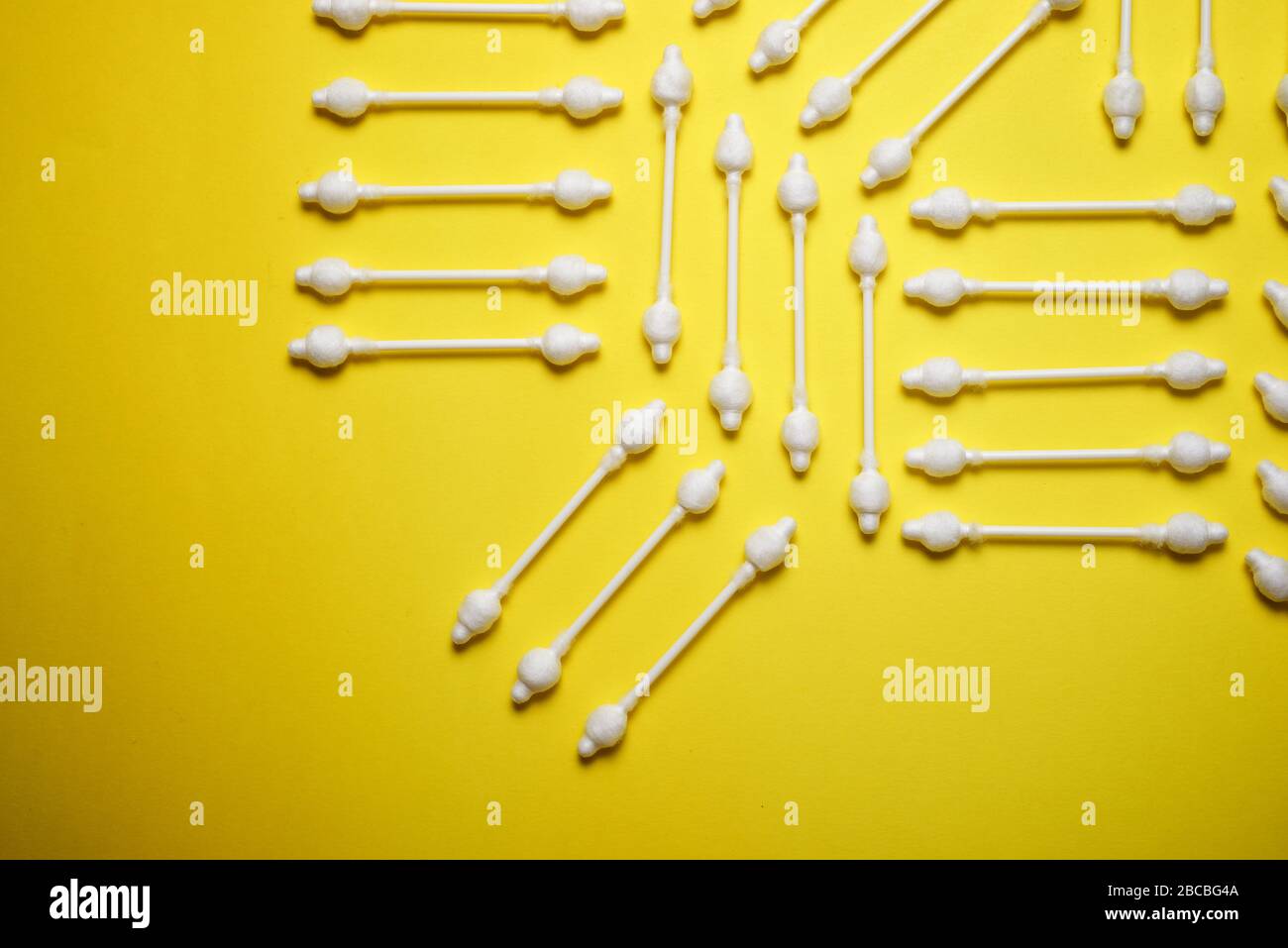 Ear swabs on a yellow table Stock Photo - Alamy