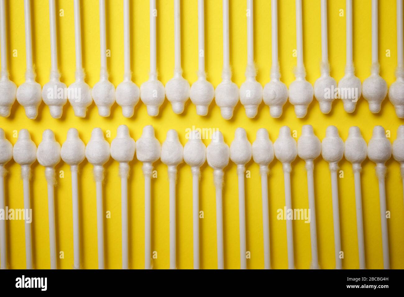 Ear swabs on a yellow table Stock Photo - Alamy