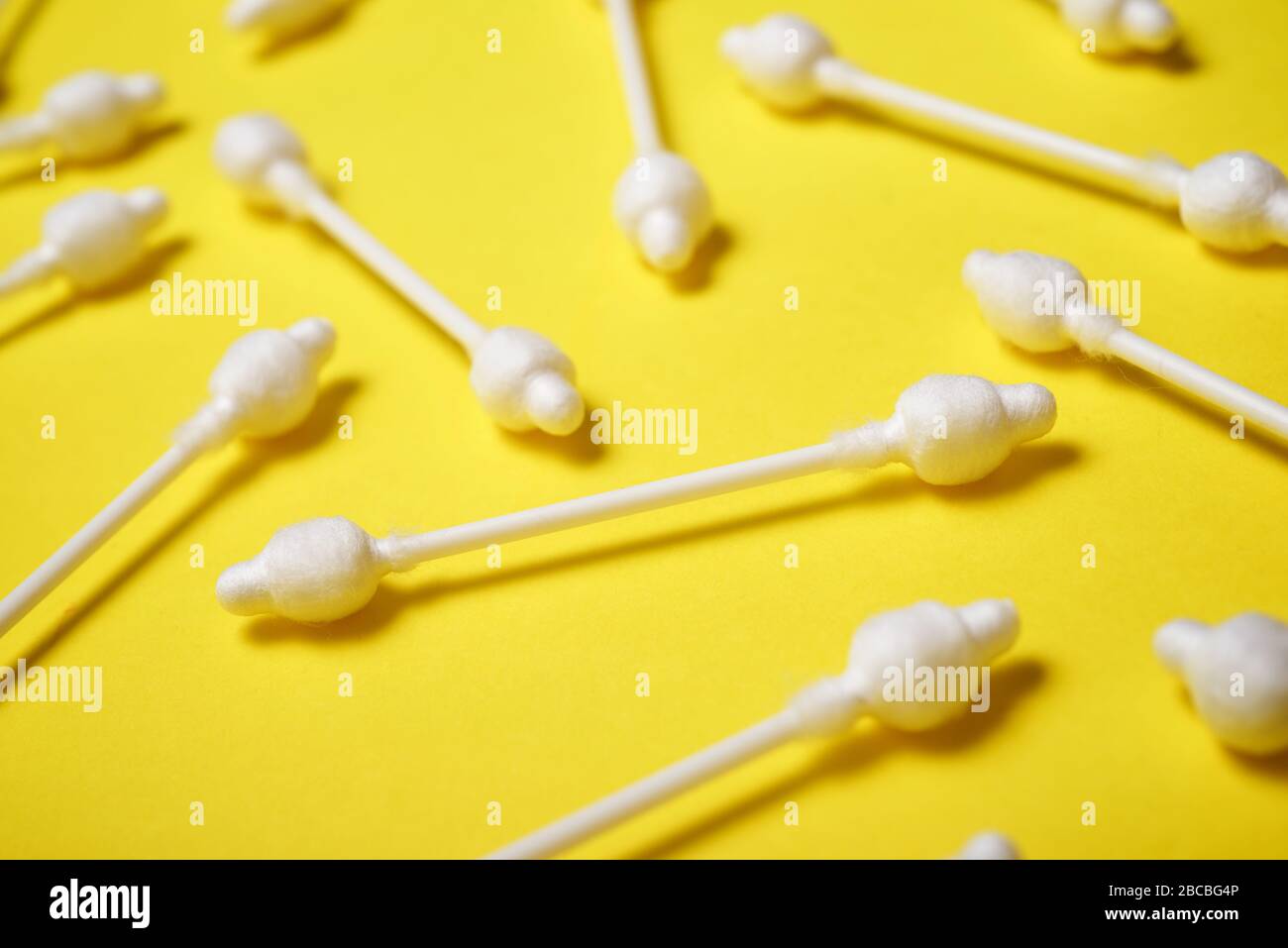 Ear swabs on a yellow table Stock Photo - Alamy