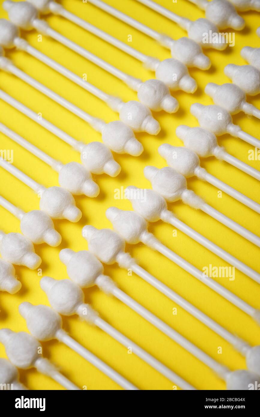 Ear swabs on a yellow table Stock Photo - Alamy