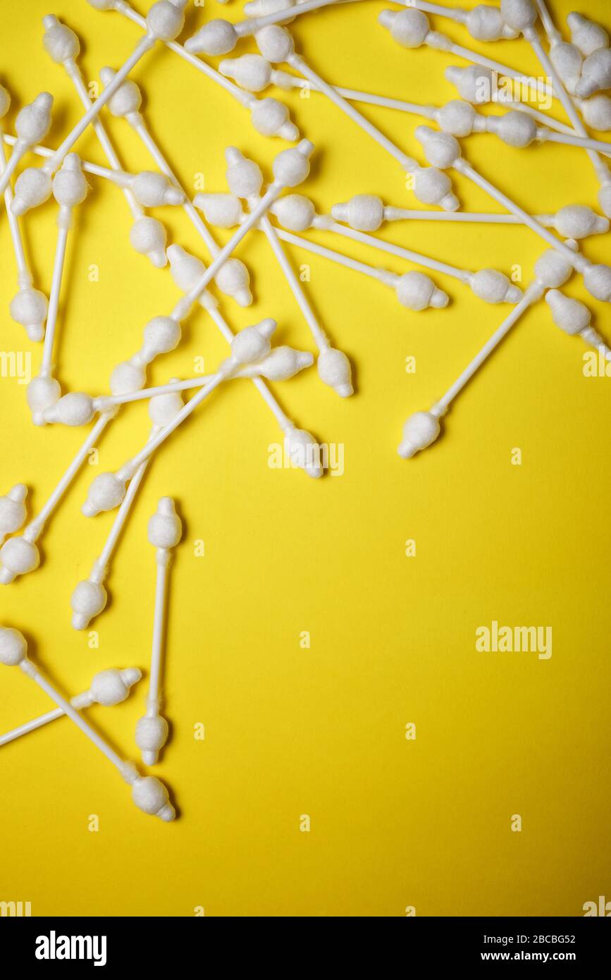 Ear swabs on a yellow table Stock Photo - Alamy
