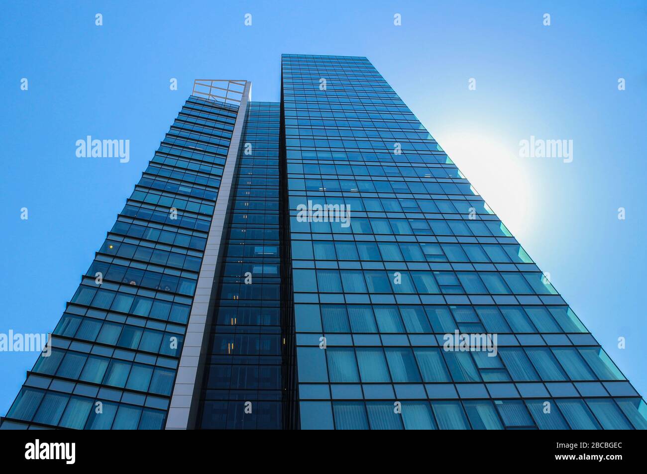 High-rise glass office building against a blue sky Stock Photo - Alamy