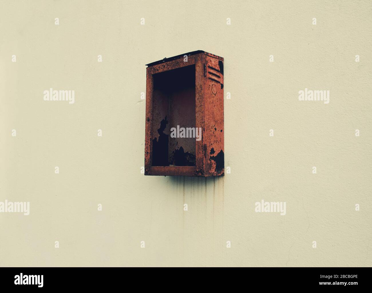 a worn and rusty box on a white wall Stock Photo - Alamy