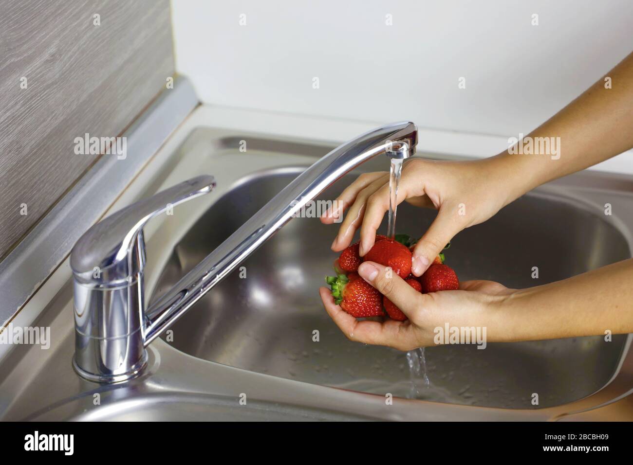 COVID-19 Pandemic Coronavirus Close up woman hands washing fruits to ...