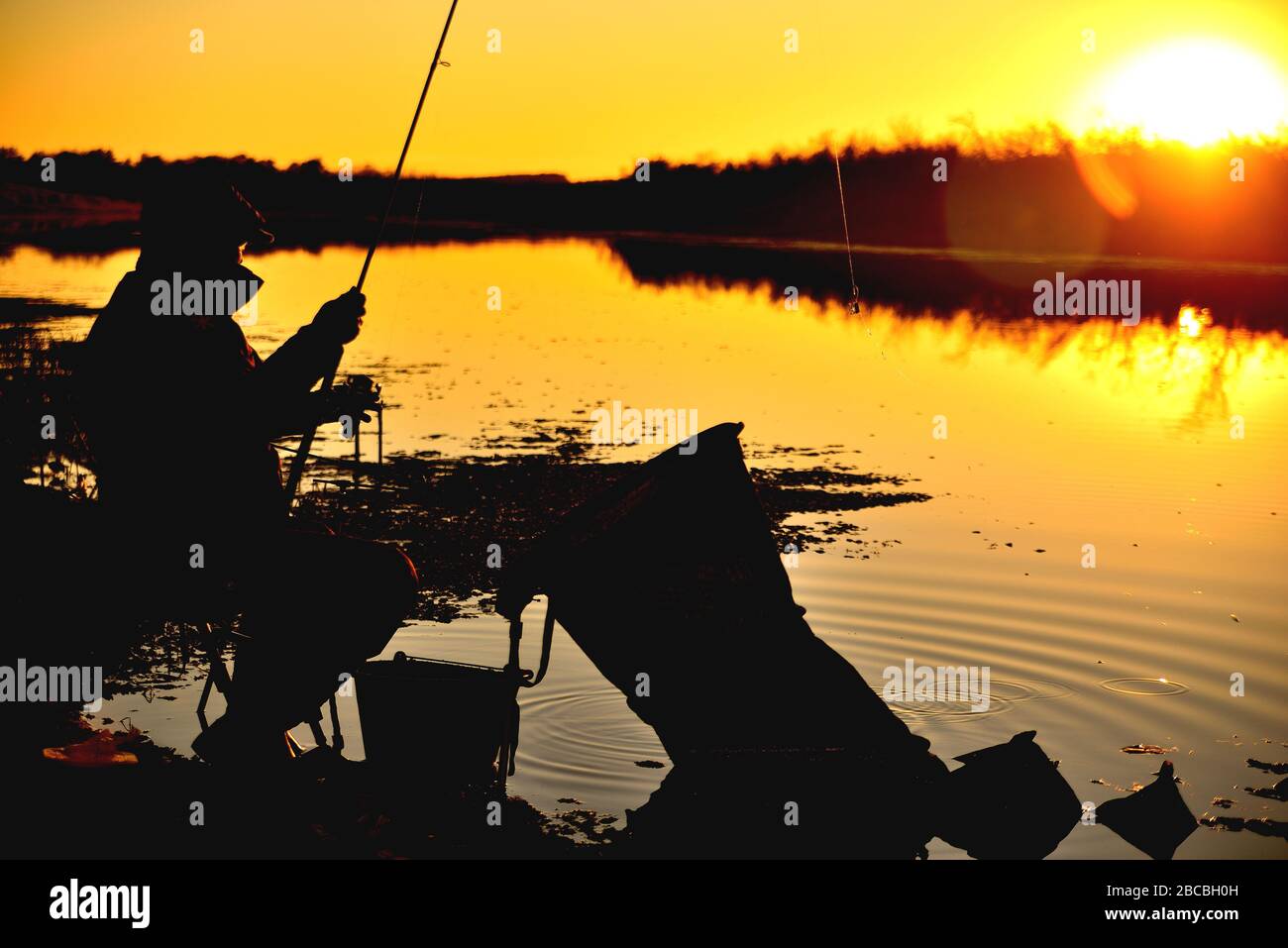 Fishing. Man. The late evening. Sunset. Autumn. The sun goes down Stock ...