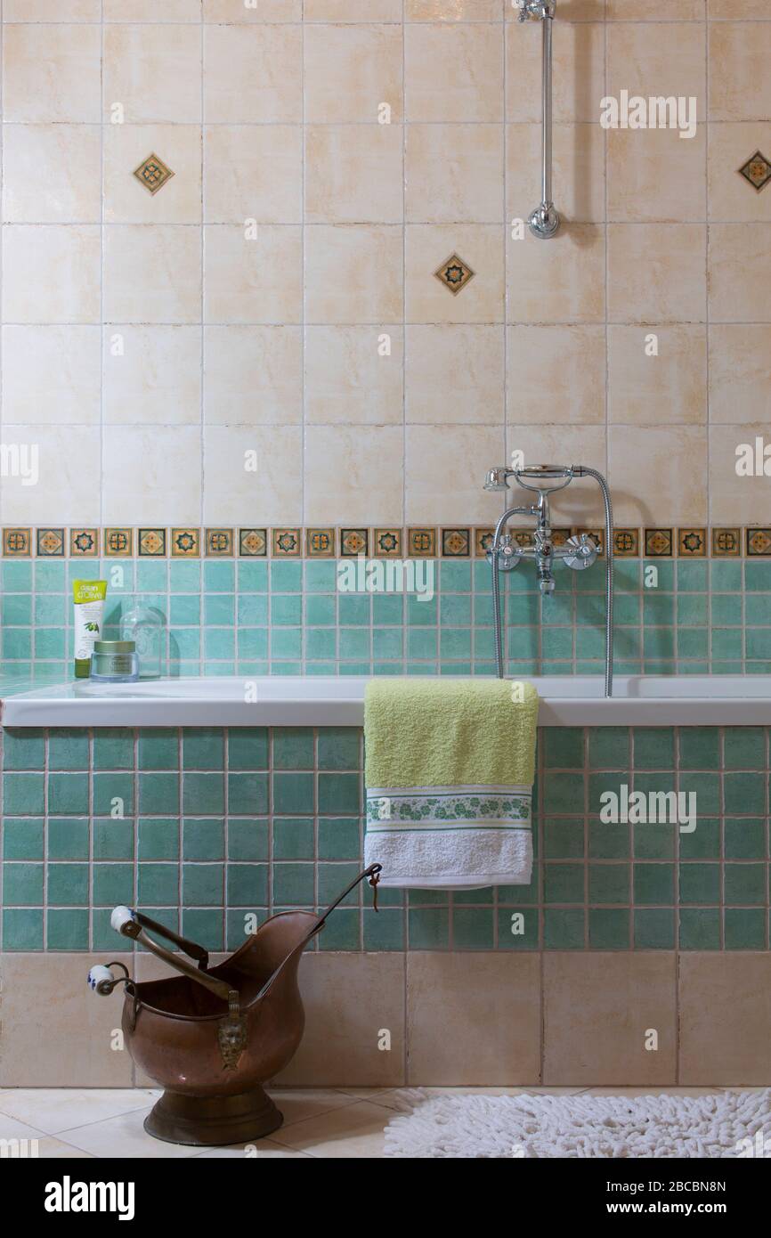 Rustic bathroom with blue tiles and copper bucket Stock Photo - Alamy