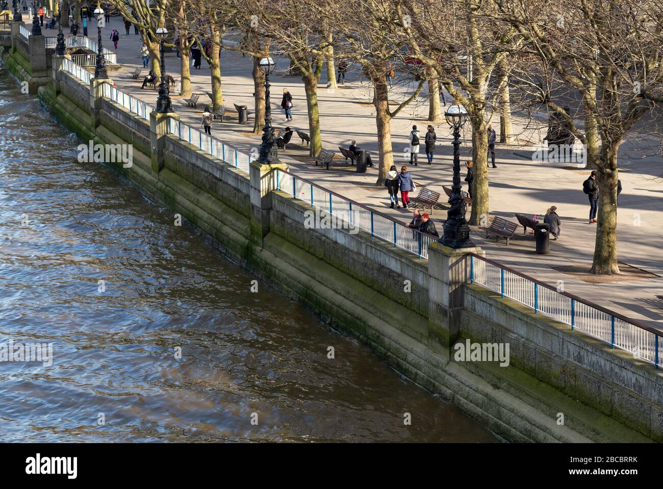 Pedestrians walking along the Thames in London Stock Photo - Alamy