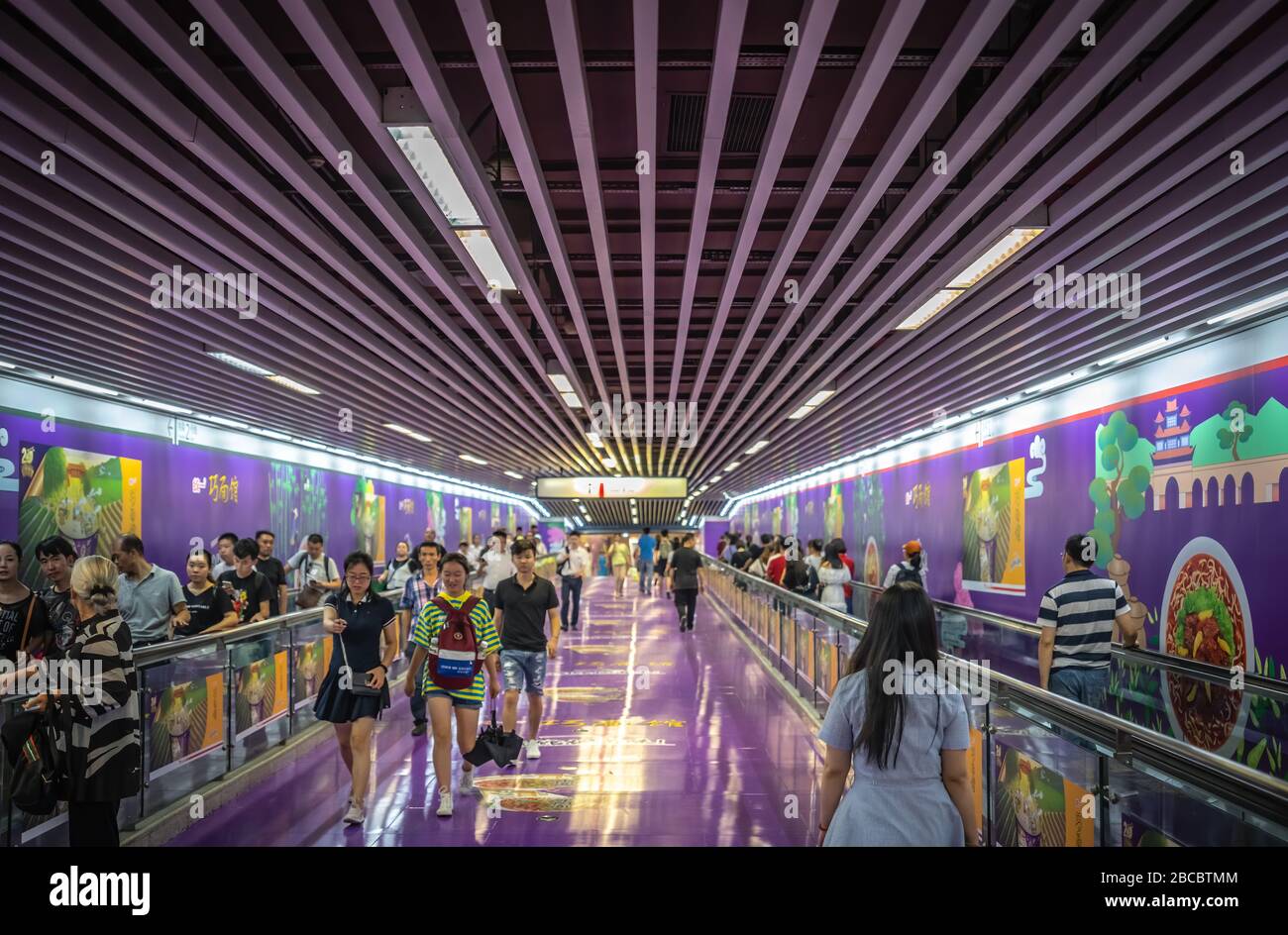 Chongqing, China - August 2019 : Commuters walking inside the colorful ...