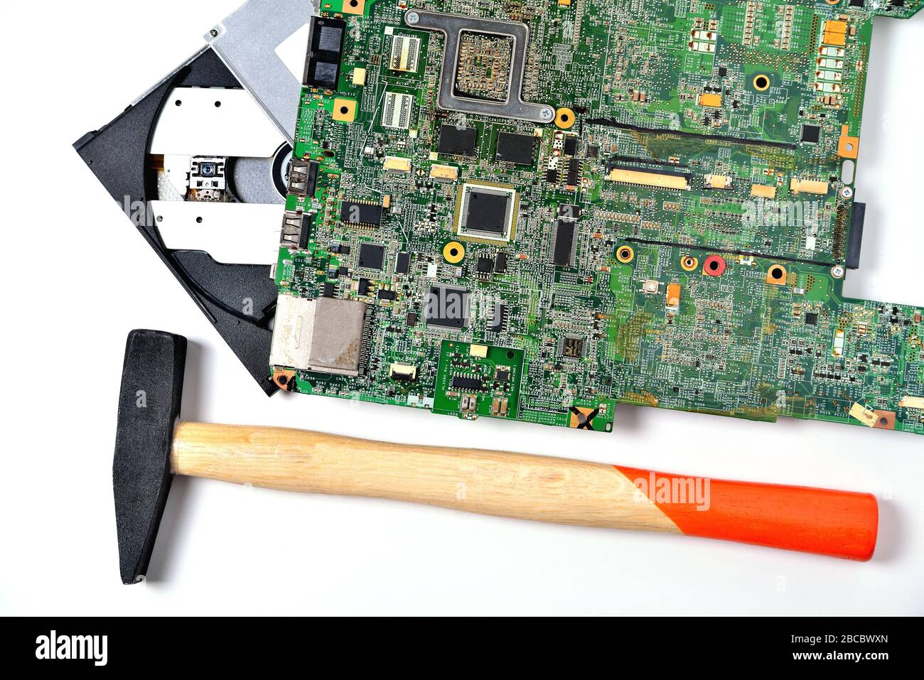 An old micro circuit for a laptop and CD rom , a hammer, White ...
