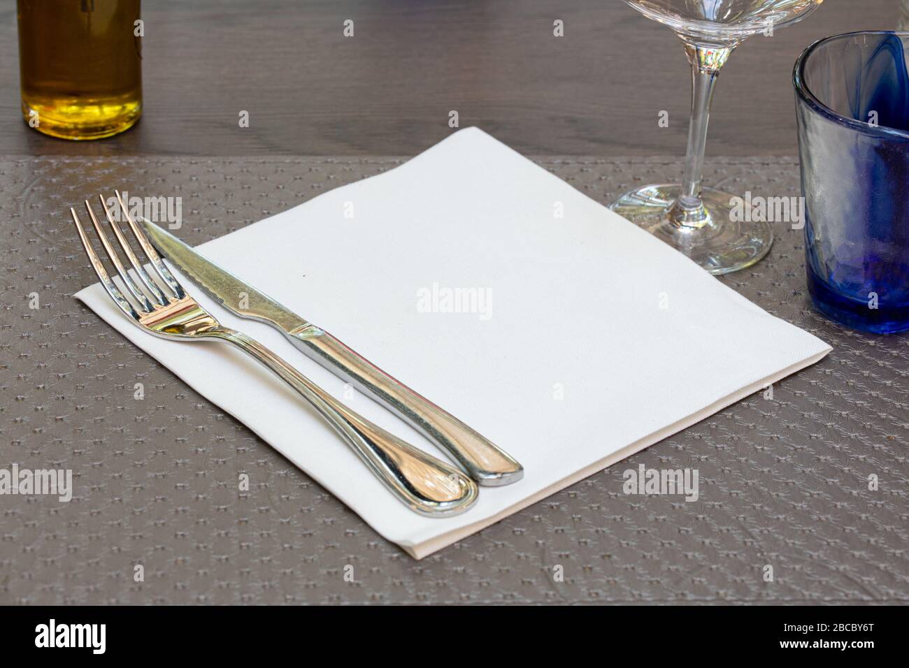 Table with cutlery in a restaurant Stock Photo - Alamy