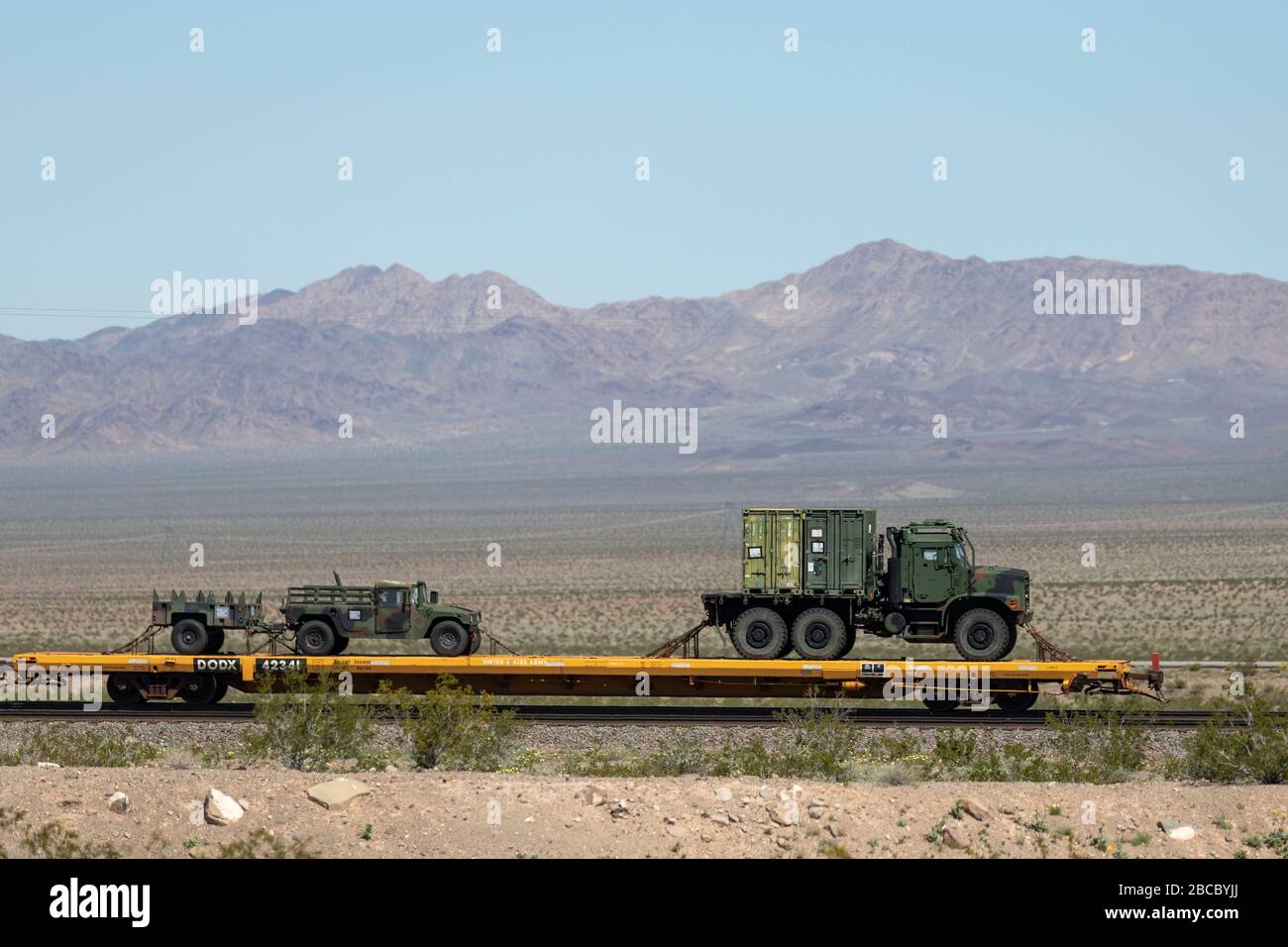 A military truck and humvee is transported to Marine Corps Logistics ...