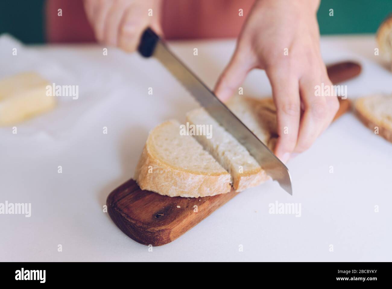 Woman cutting bread hi-res stock photography and images - Alamy
