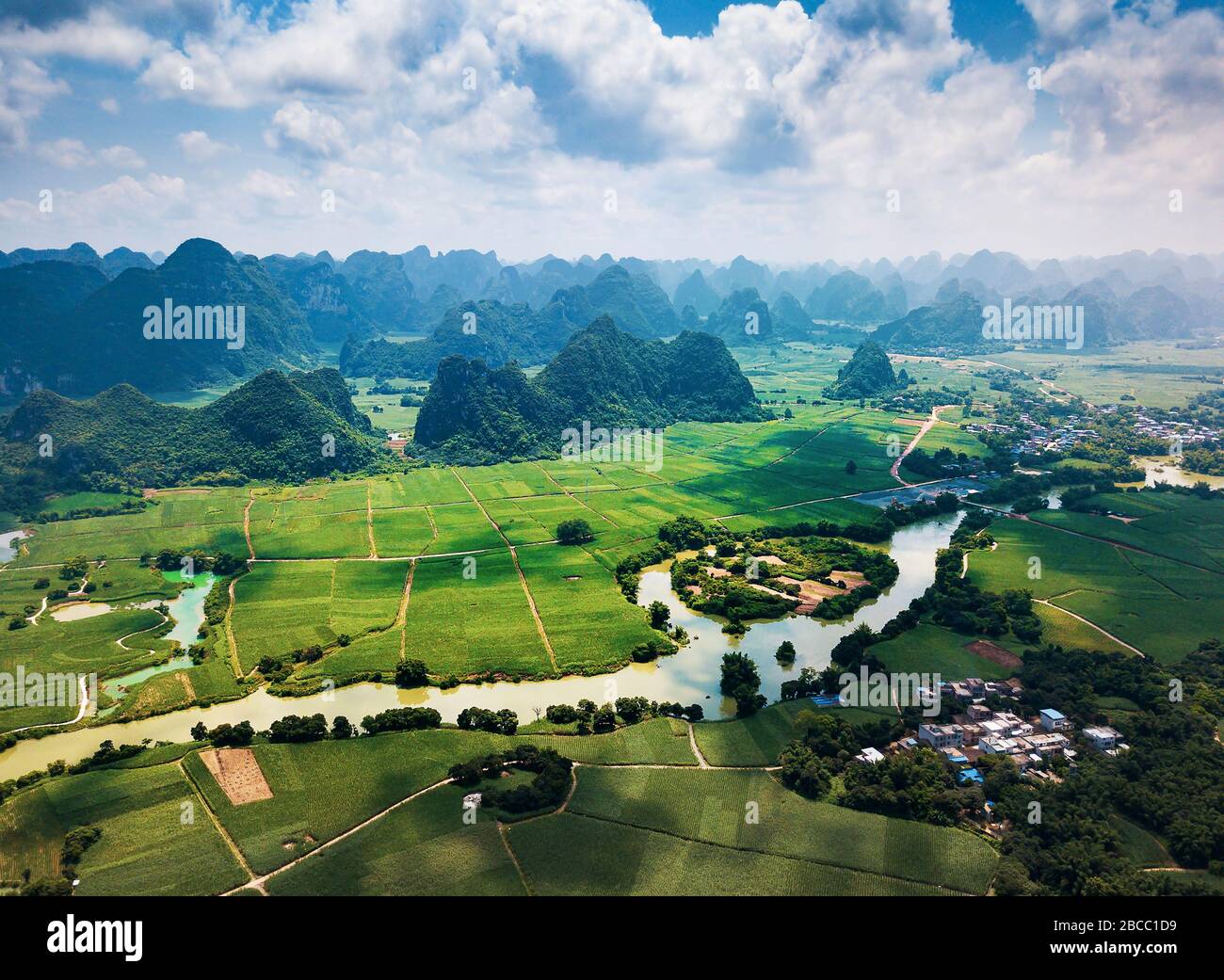 Rural Chinese landscape of limestone rocks and scenic river around rice ...