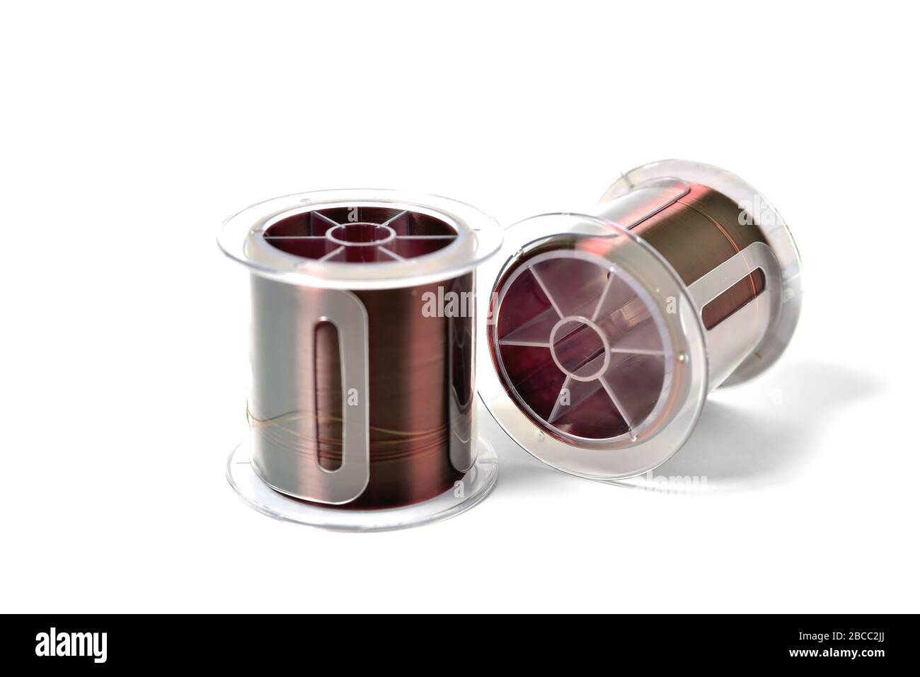 fishing line in reels of brown color on a white background, close-up ...