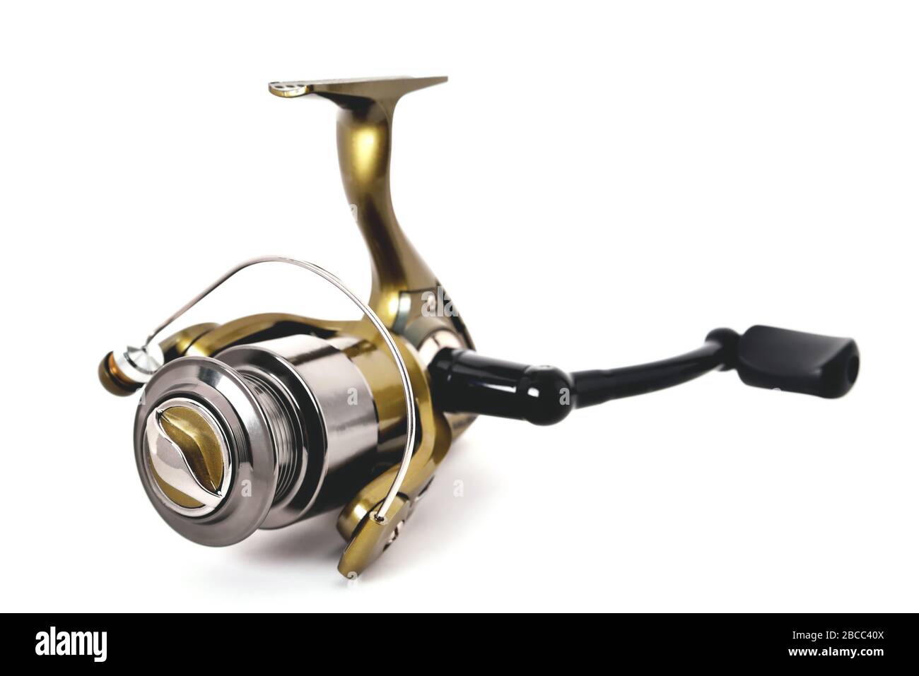 gold color fishing reel on a white background Stock Photo - Alamy