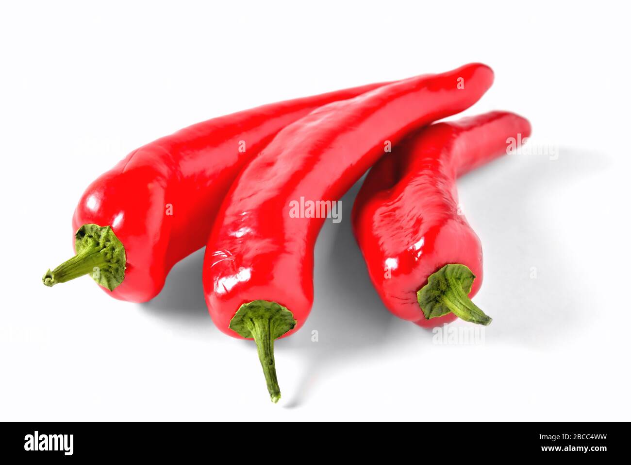 three red peppers elongated shape on white background, isolate Stock ...
