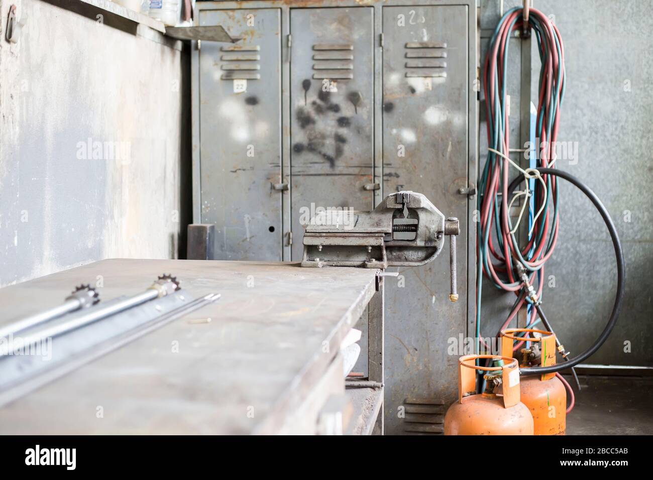 Old rustic mechanical vice grip tool on workbench at metal workshop ...