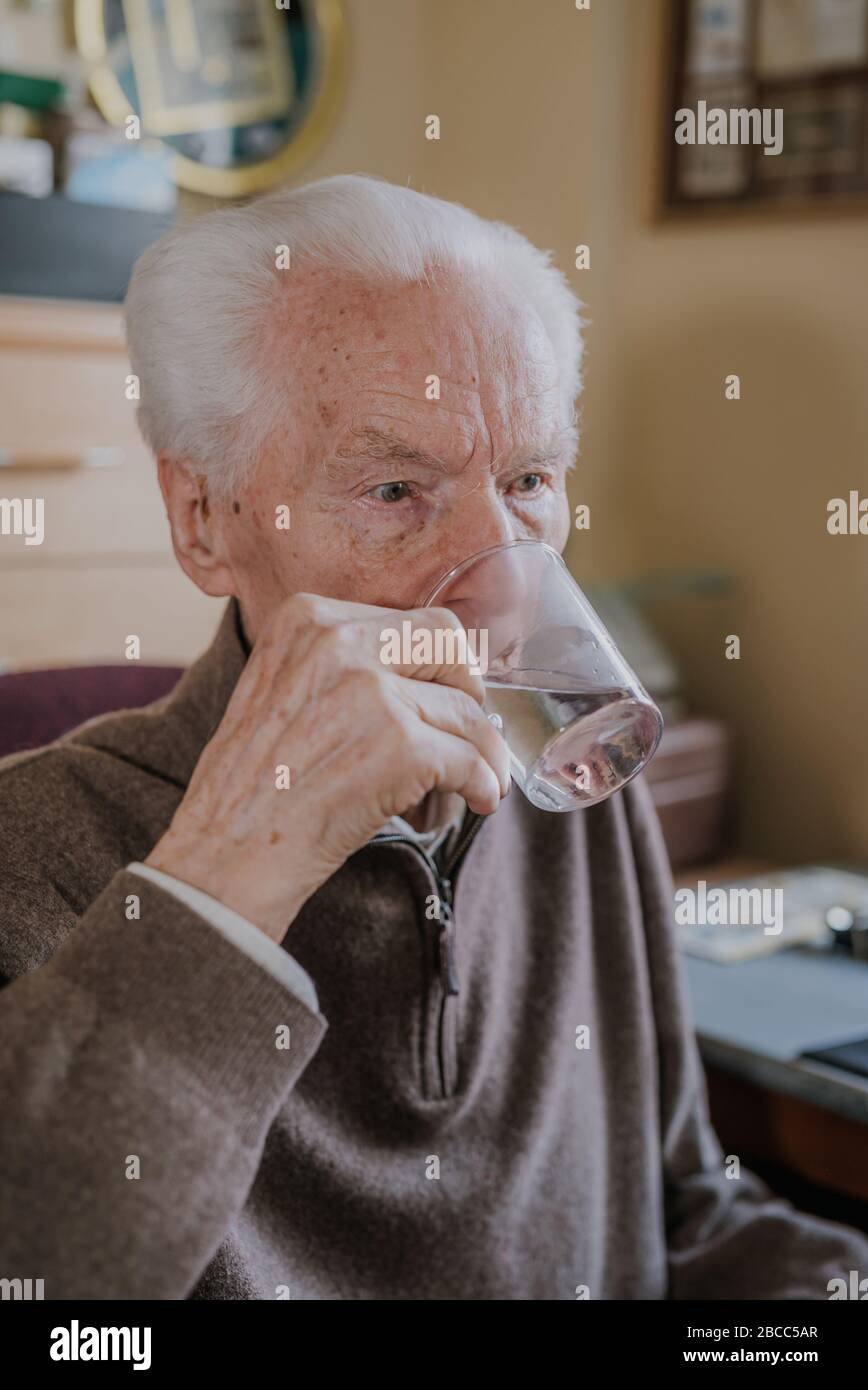 Senior drinking water. Caring for good hydration during Coronavirus ...