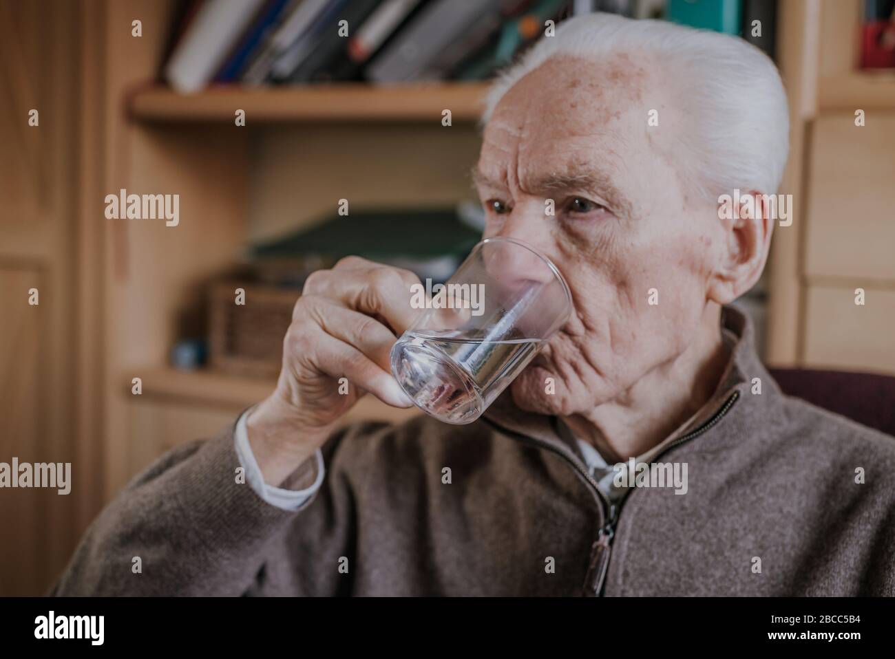 Senior drinking water. Caring for good hydration during Coronavirus ...