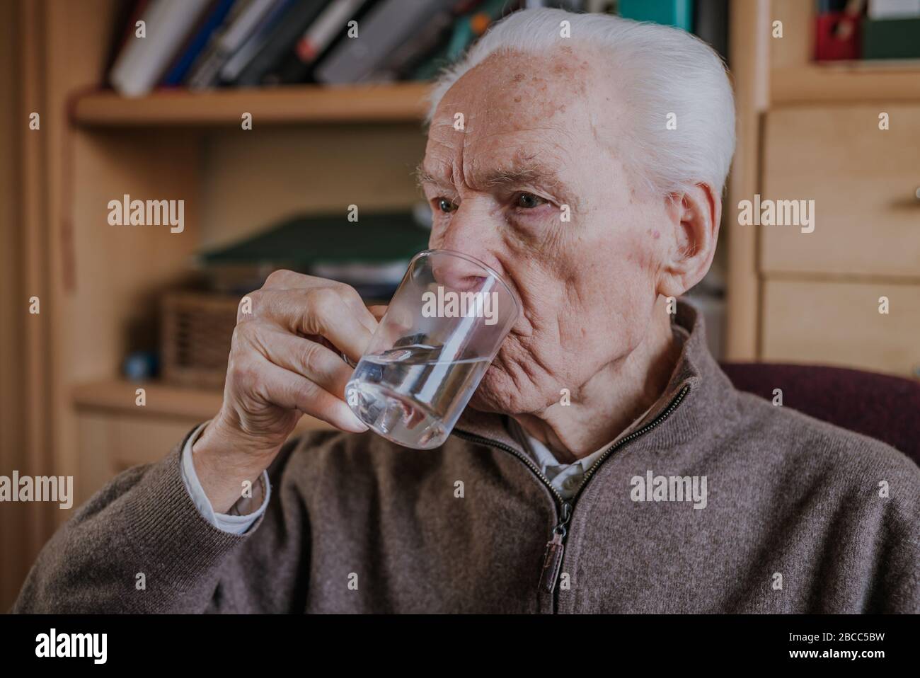 Senior drinking water. Caring for good hydration during Coronavirus ...