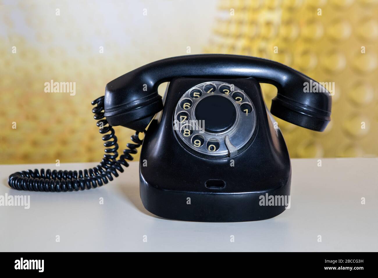 An old phone with rotary dial against a 70's looking background Stock ...