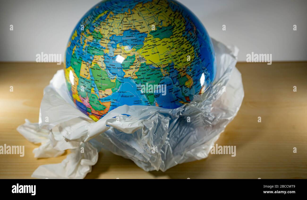 Earth inside a plastic and some garbage. Earth is being destroyed ...